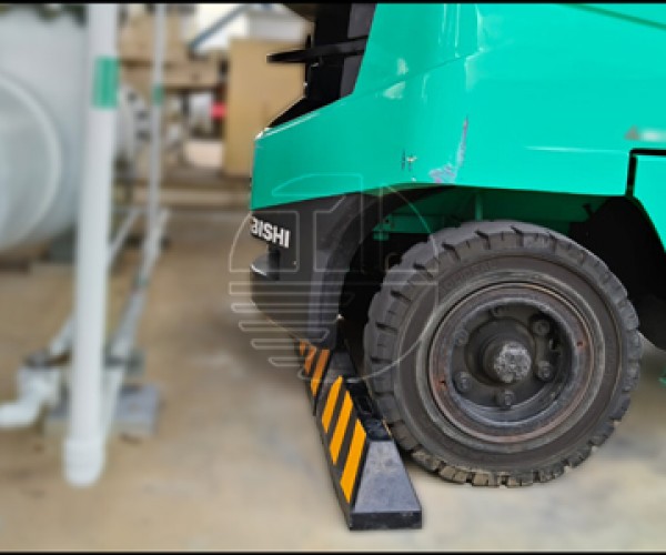 Rubber Truck Wheel Stopper installed at a manufacturing facility ...